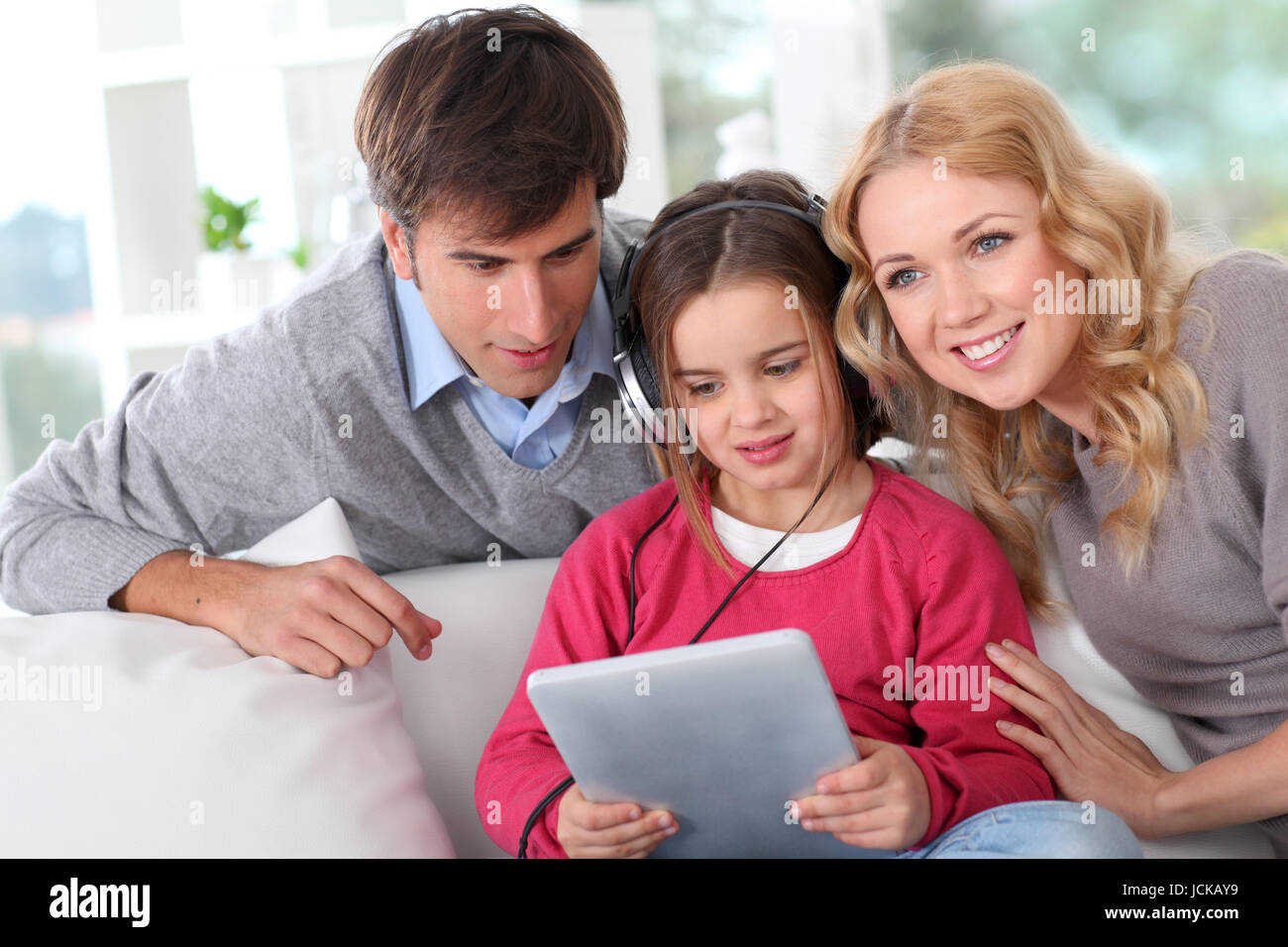 Family listening to music with tablet Stock Photo - Alamy