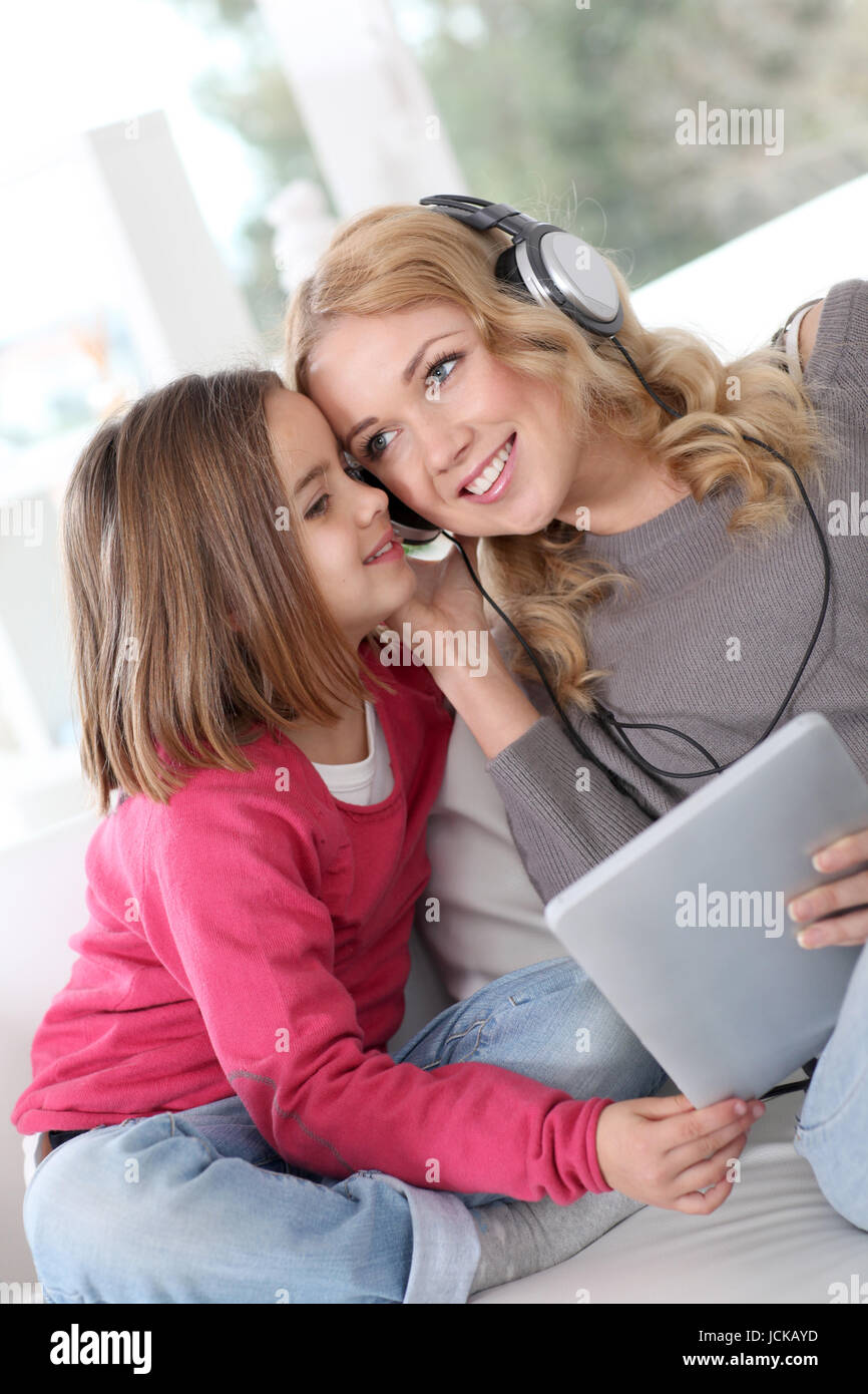 Mother and daughter listening to music Stock Photo - Alamy