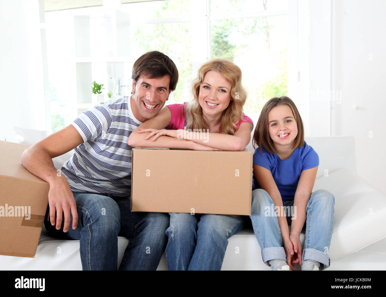 Family moving in new house Stock Photo - Alamy