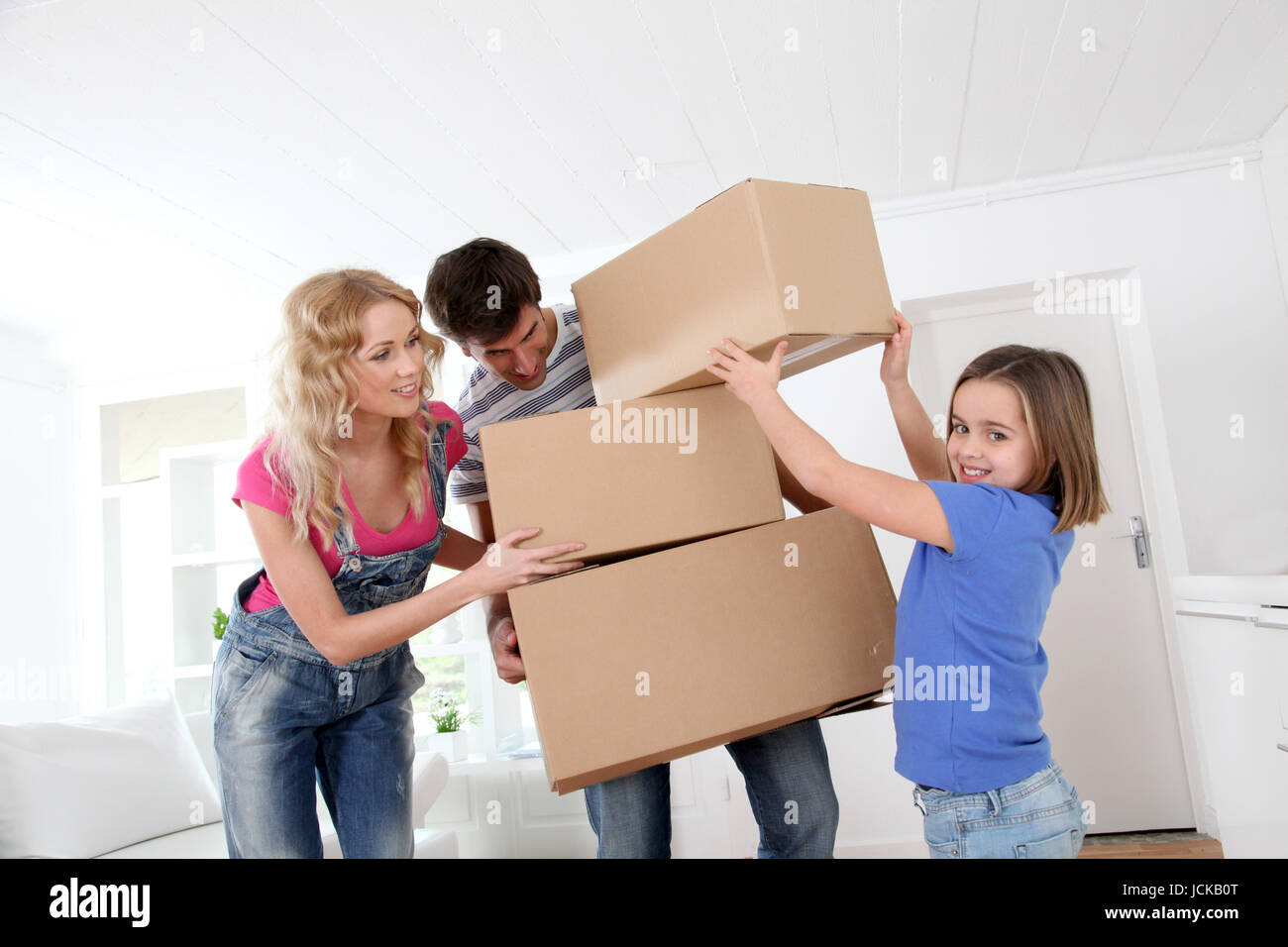 Family moving in new house Stock Photo - Alamy