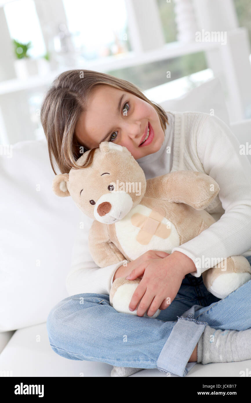 Sick little girl hugging sick teddy bear Stock Photo - Alamy