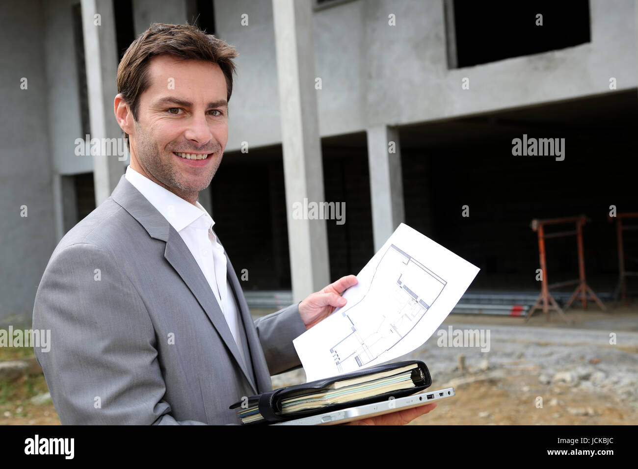 Construction salesman checking building site Stock Photo - Alamy