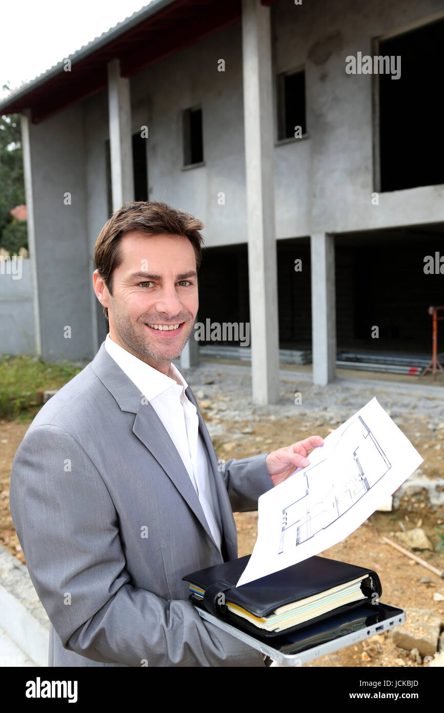 Construction salesman checking building site Stock Photo - Alamy