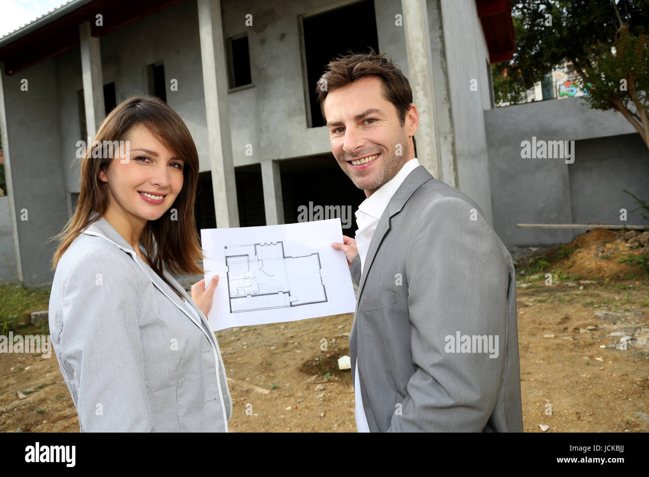 Couple on construction site checking building progress Stock Photo - Alamy
