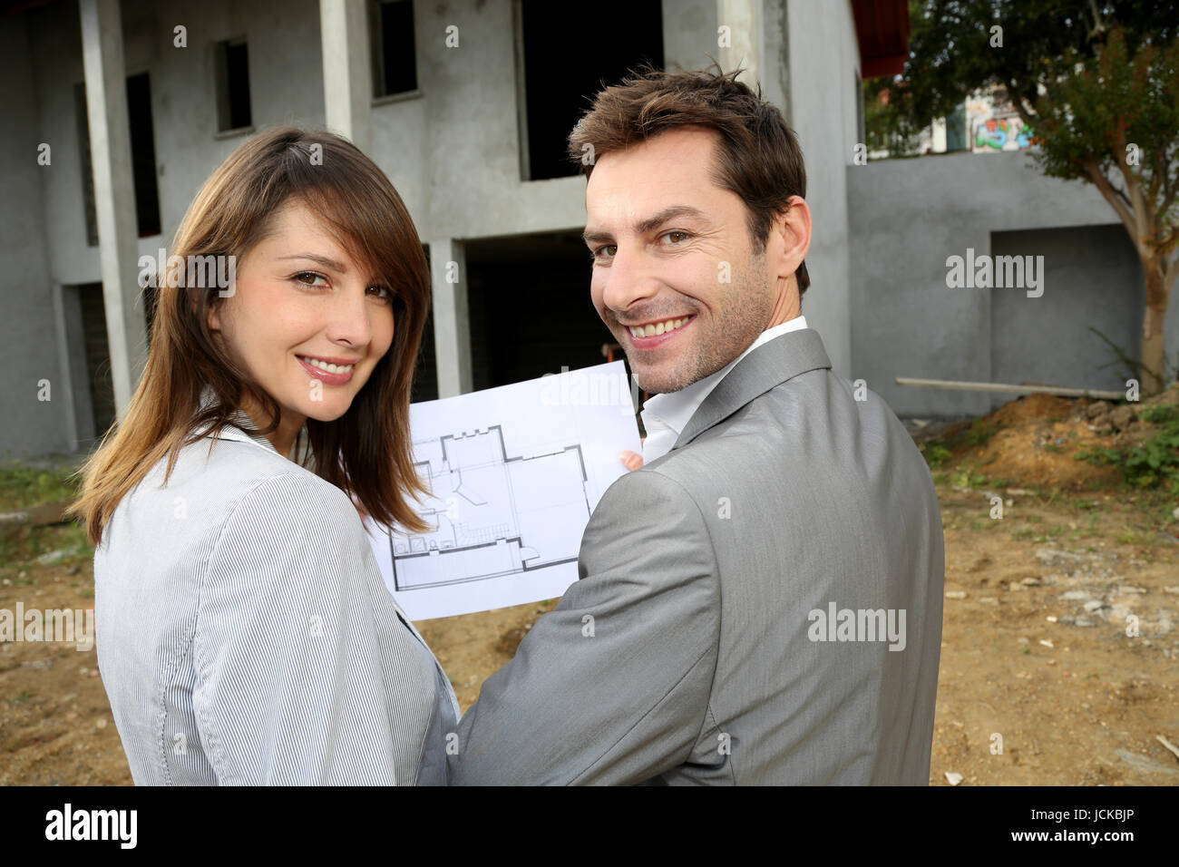Couple on construction site checking building progress Stock Photo - Alamy
