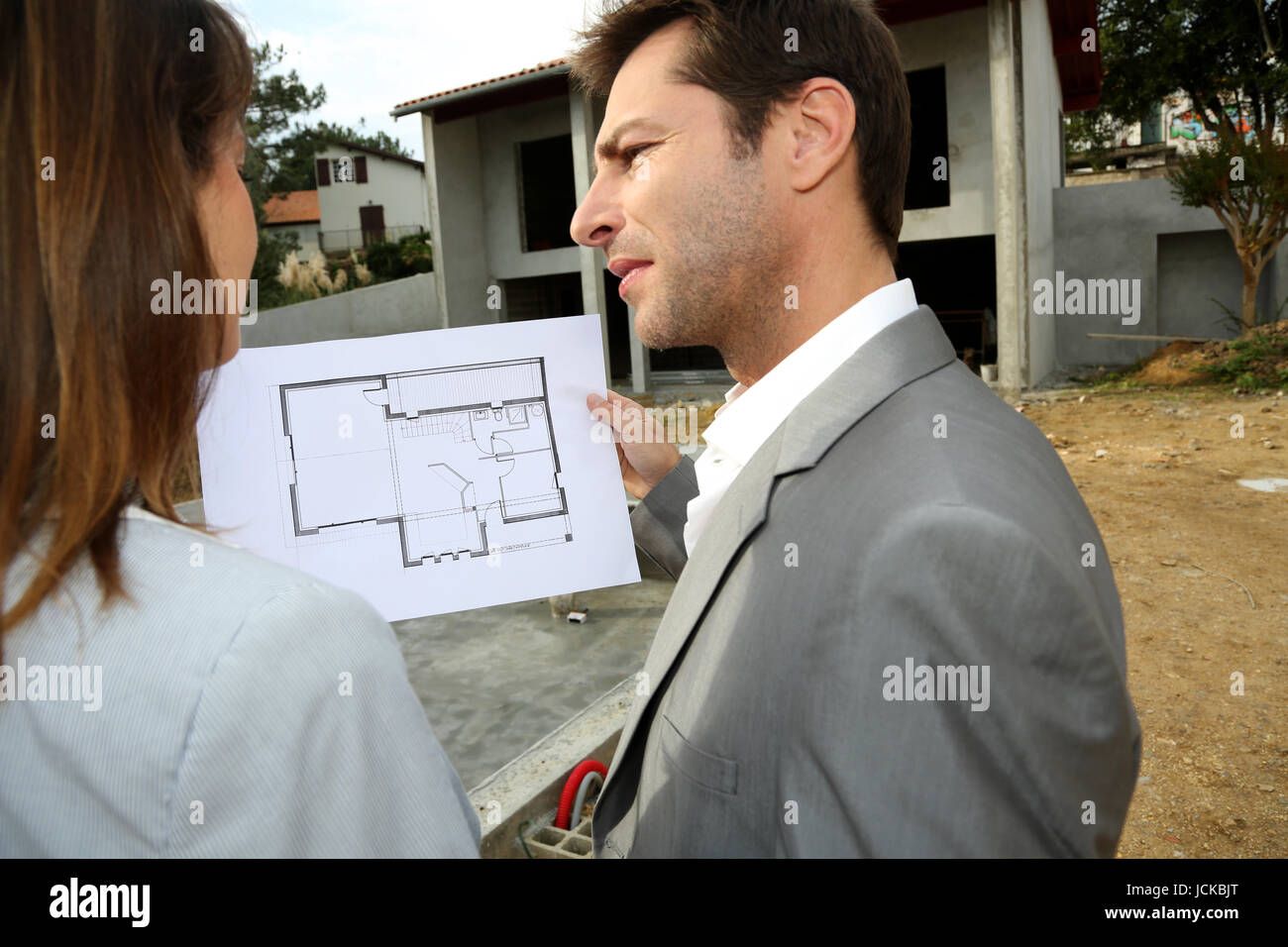 Couple on construction site checking building progress Stock Photo - Alamy