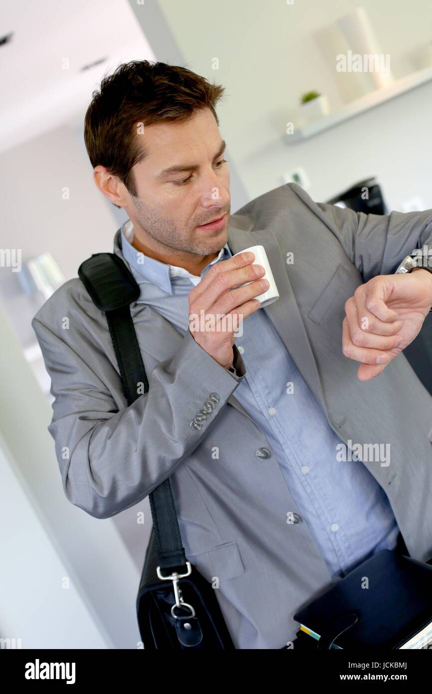 Man looking watch rushing work hi-res stock photography and images - Alamy