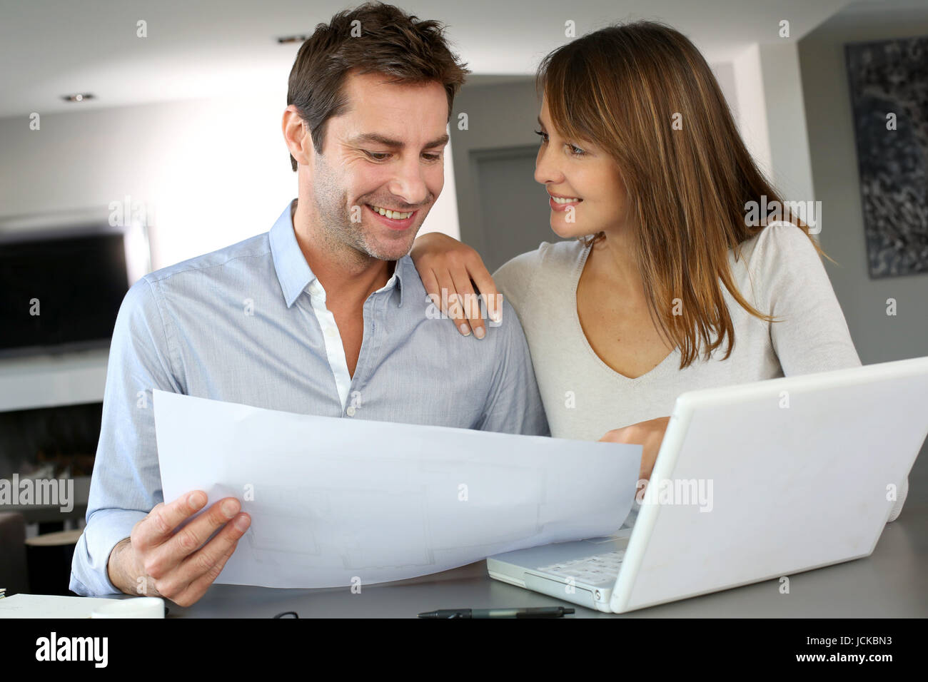 Couple looking at future home blueprint Stock Photo - Alamy