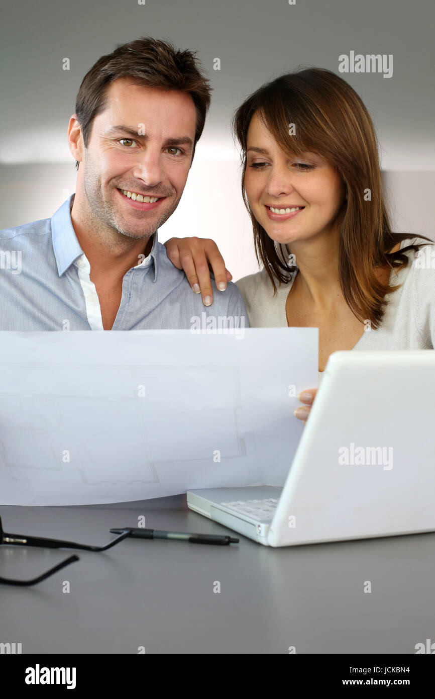 Couple looking at future home blueprint Stock Photo - Alamy
