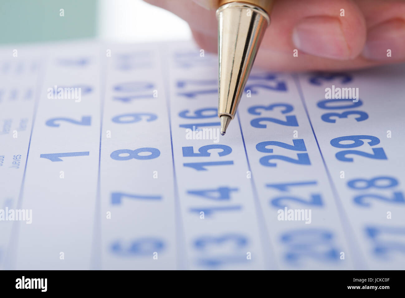 Closeup of man's hand marking date 15 on calendar Stock Photo - Alamy