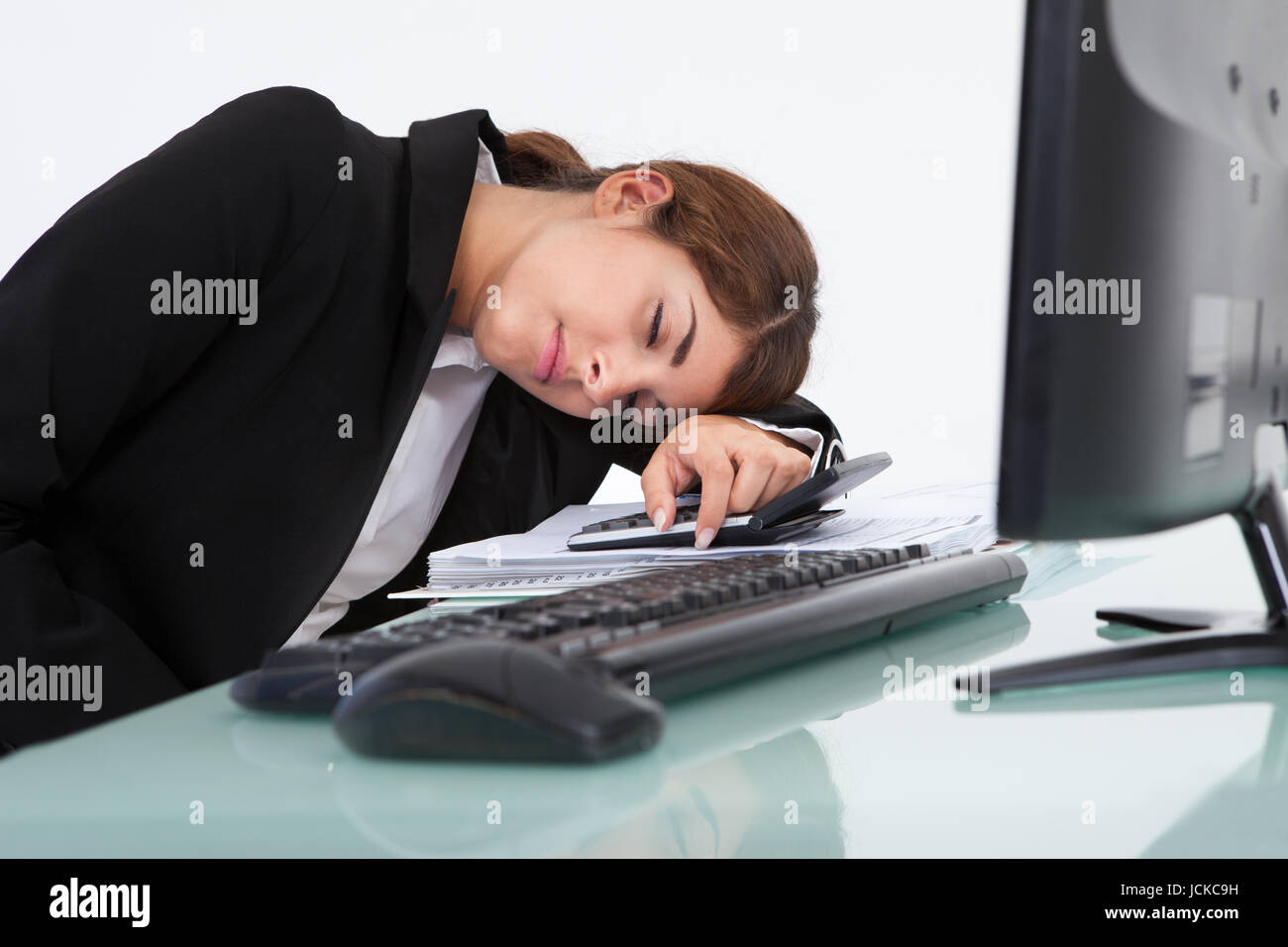 Stressed young businesswoman leaning at computer desk in office Stock ...