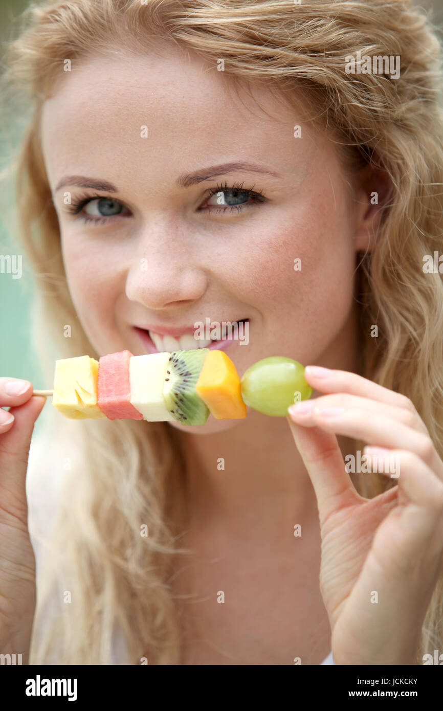 Portrait of beautiful woman eating fresh exotic fruits Stock Photo - Alamy