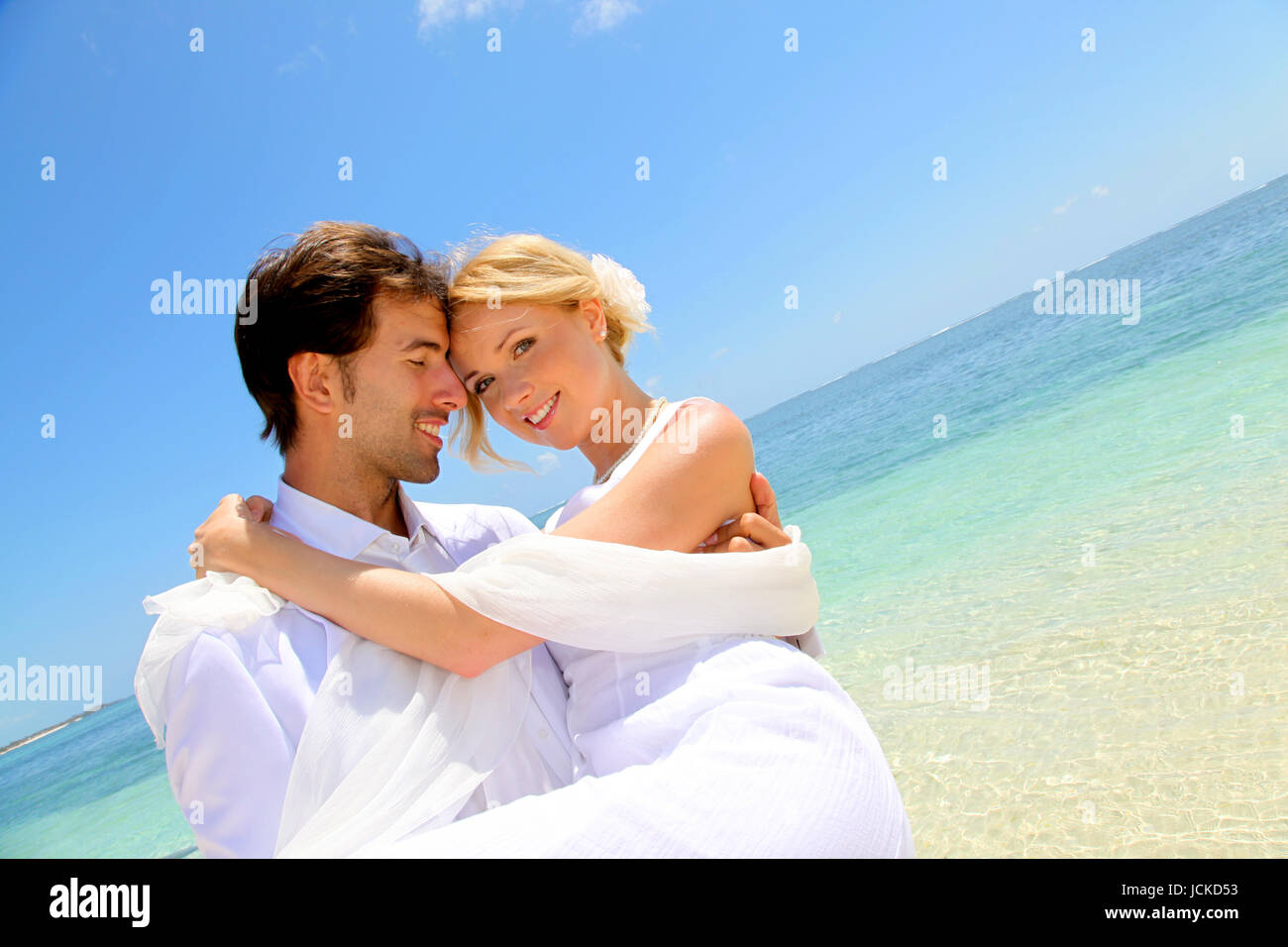 Groom carrying bride in arms hi-res stock photography and images - Alamy