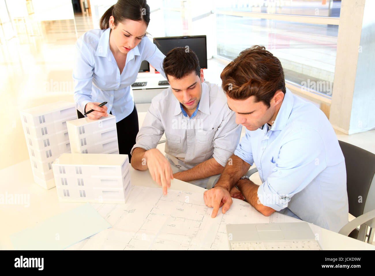 Team of architects working on project Stock Photo - Alamy