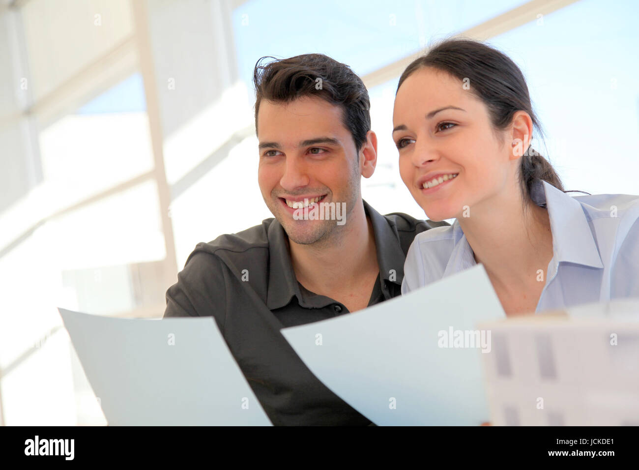 Happy young couple signing property purchase contract Stock Photo - Alamy