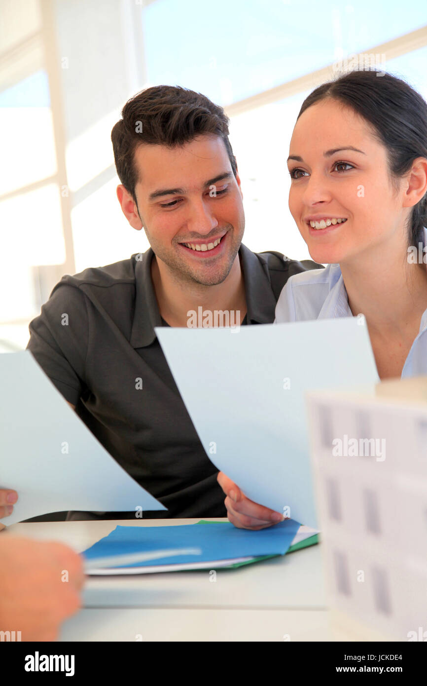 Happy young couple signing property purchase contract Stock Photo - Alamy