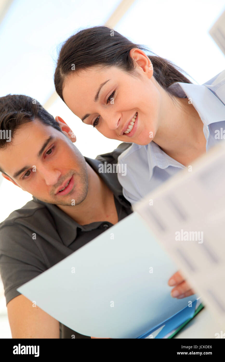 Happy young couple signing property purchase contract Stock Photo - Alamy