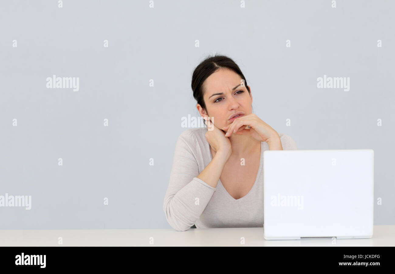 Young woman in front of laptop computer isolated Stock Photo - Alamy