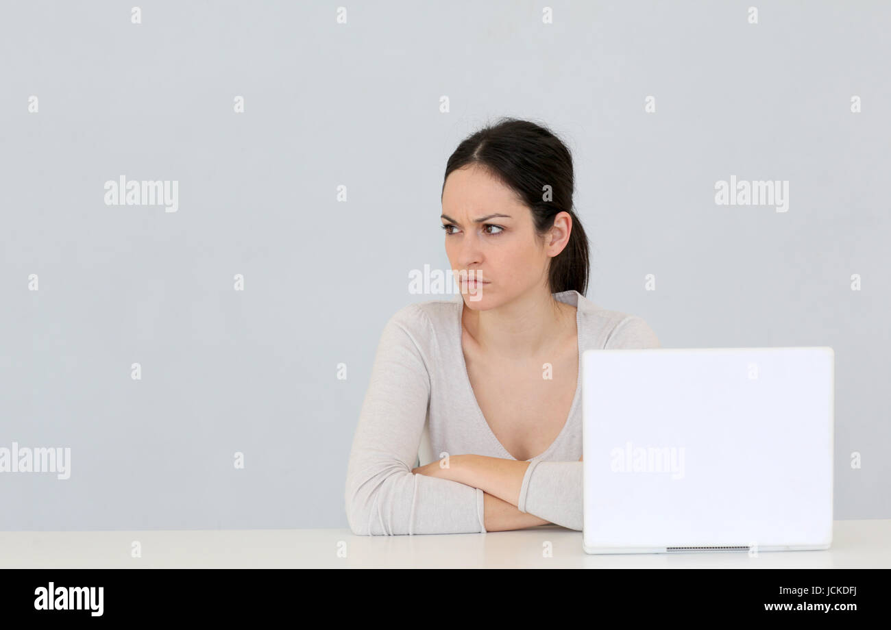 Young woman in front of laptop computer isolated Stock Photo - Alamy