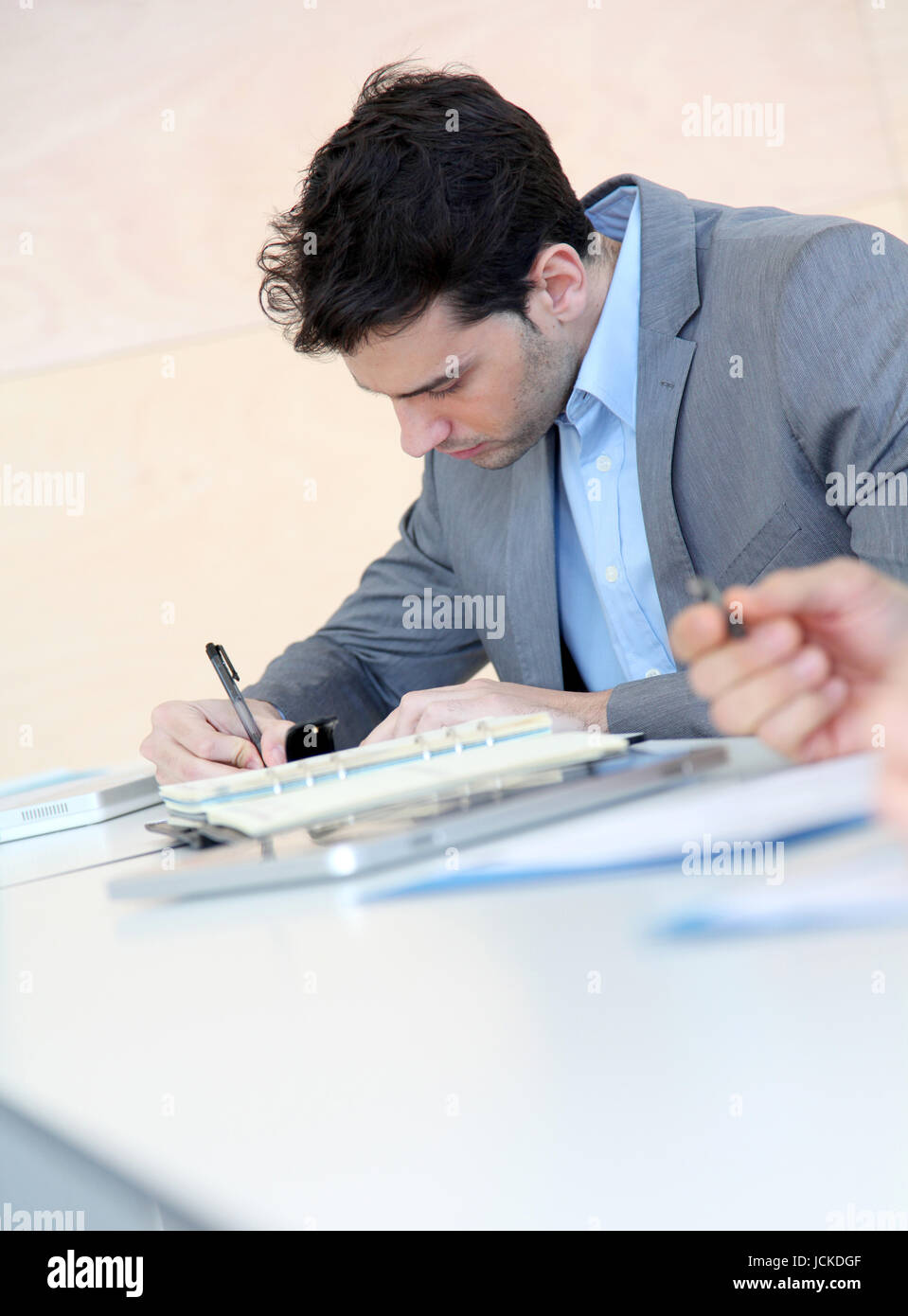 Young man filling in application form Stock Photo - Alamy