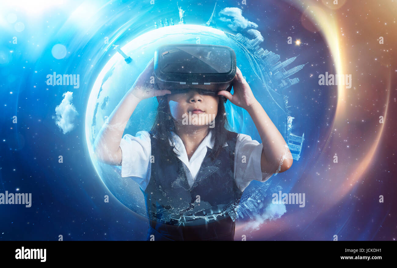 Little asian cute girl wearing virtual reality goggles with amazing ...