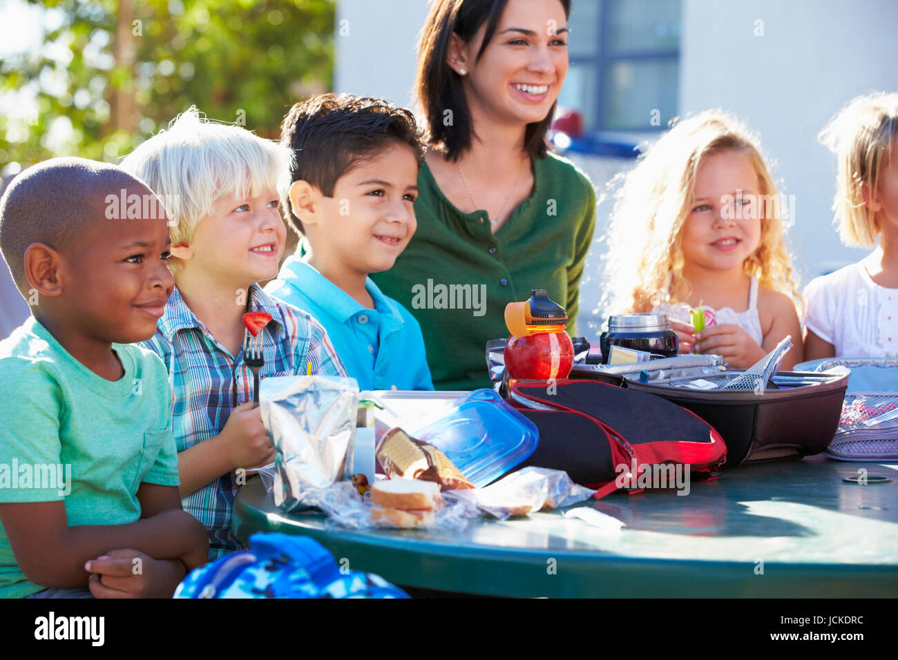 Elementary Pupils And Teacher Eating Lunch Stock Photo - Alamy