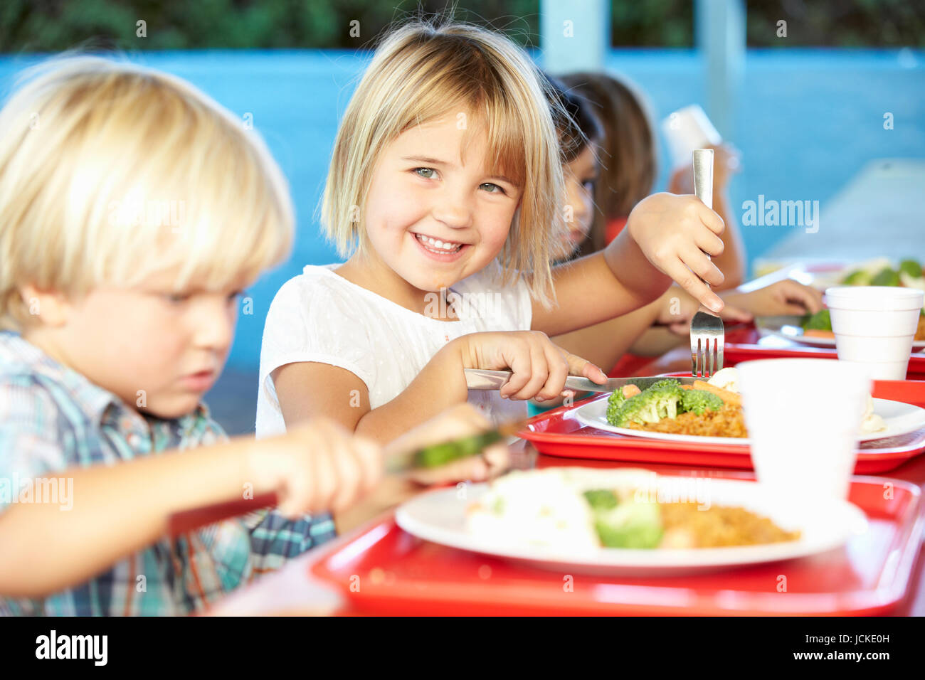 Elementary Pupils Enjoying Healthy Lunch In Cafeteria Stock Photo - Alamy