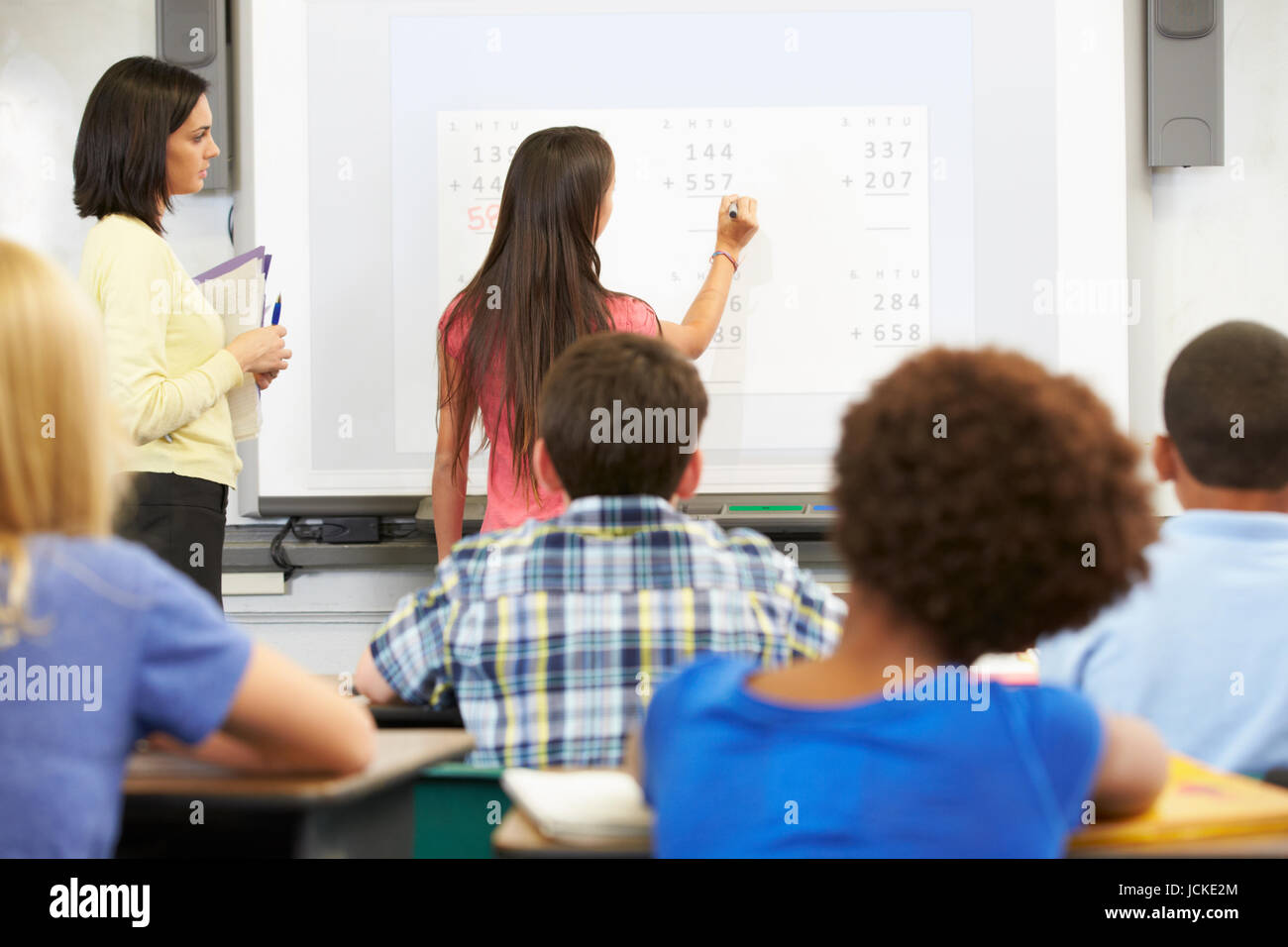 Female Student Writing Answer On Whiteboard Stock Photo - Alamy