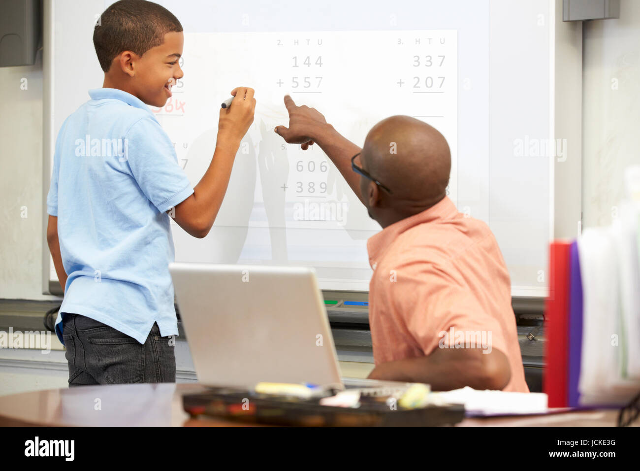 Male Student Writing Answer On Whiteboard Stock Photo - Alamy