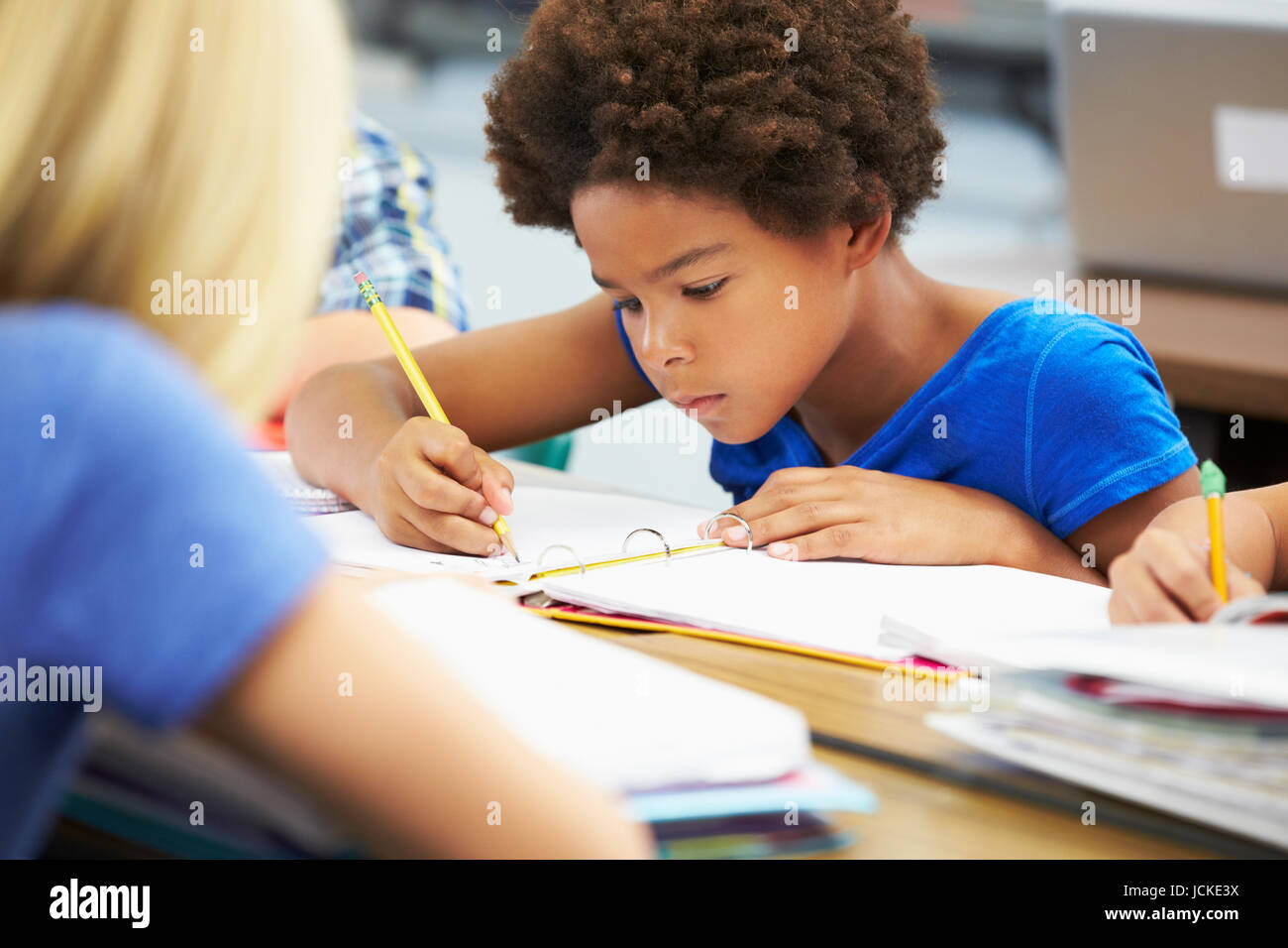 Pupils Studying At Desks In Classroom Stock Photo - Alamy