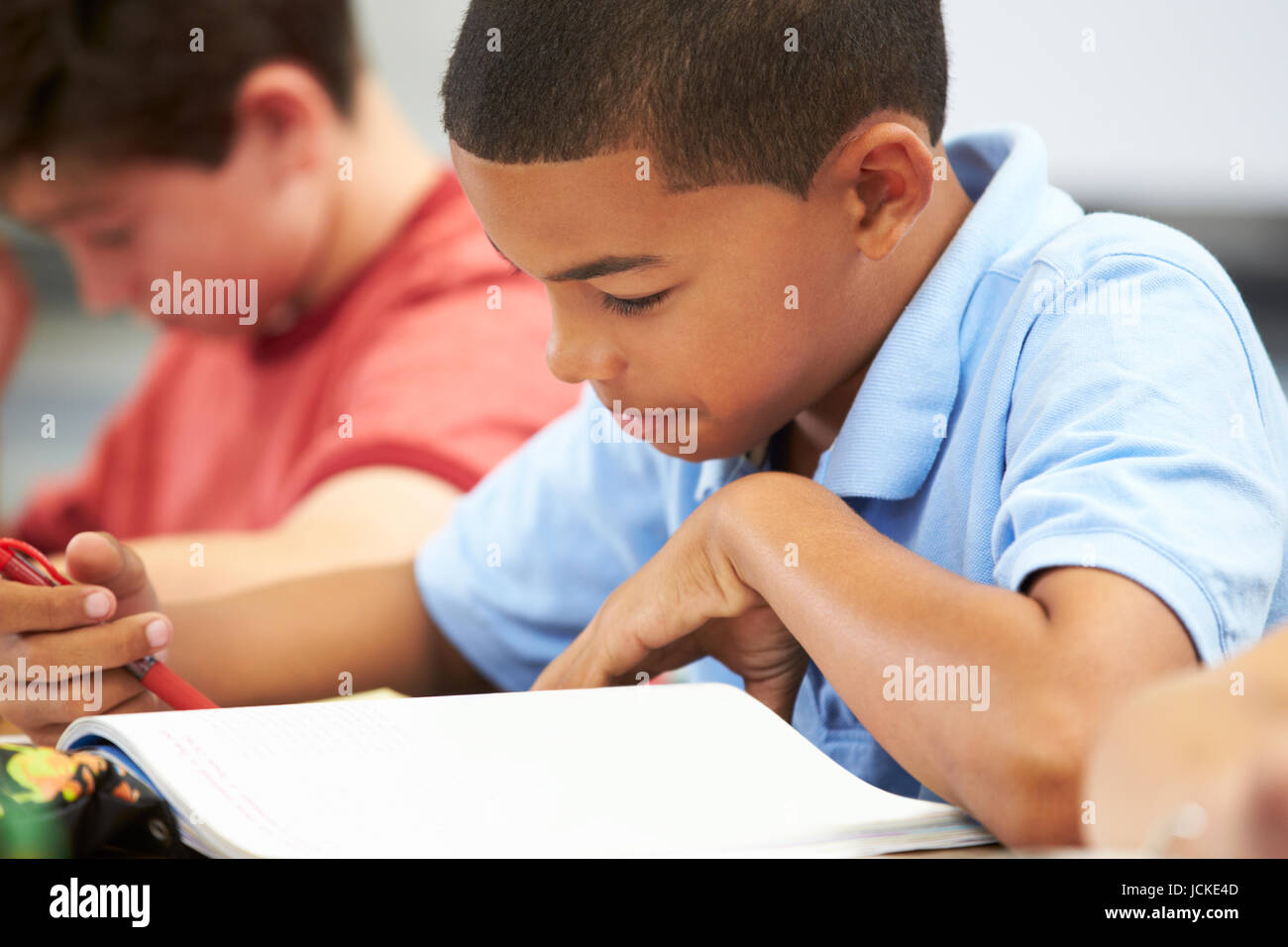 Pupils Studying At Desks In Classroom Stock Photo - Alamy