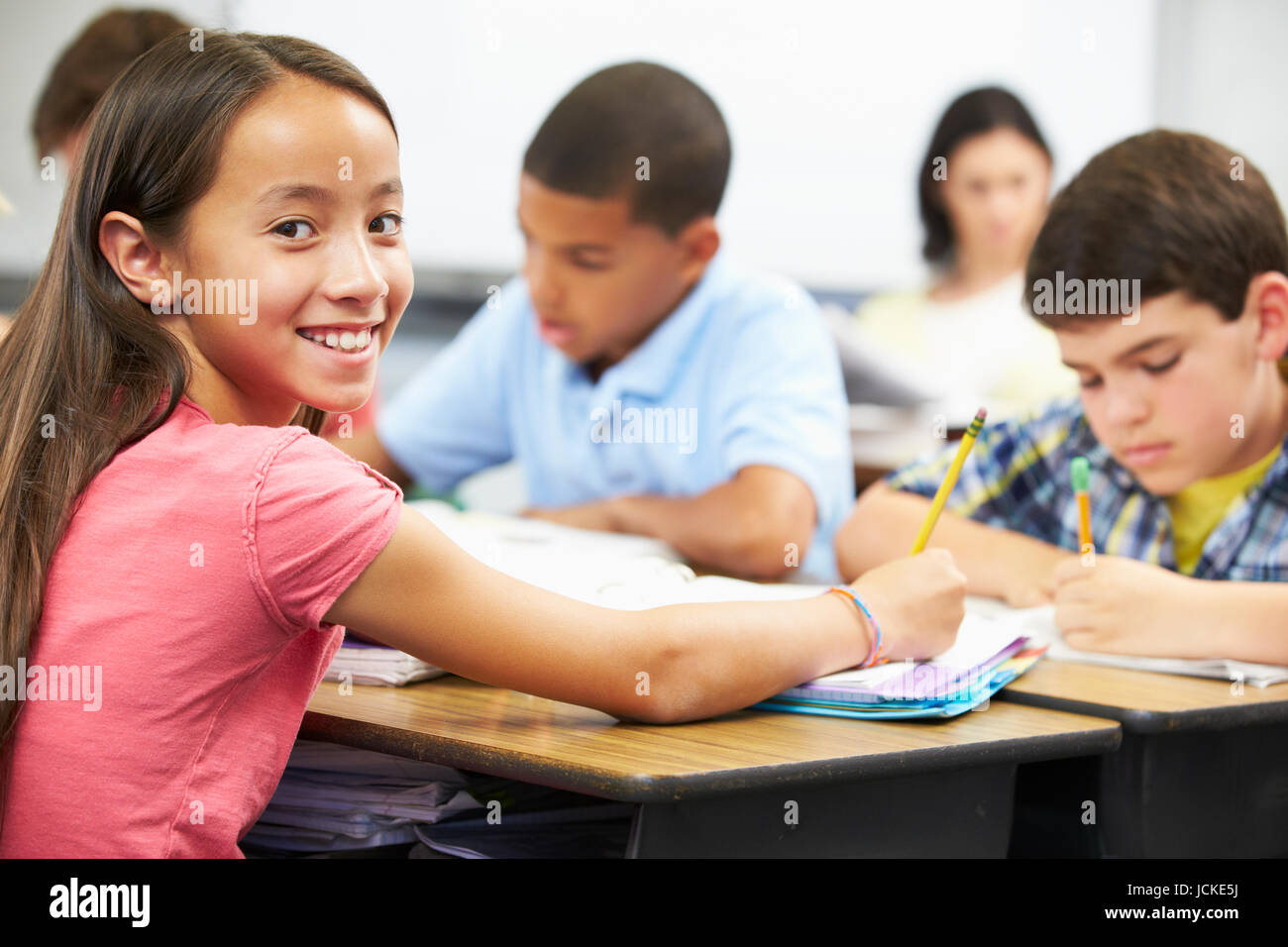 Pupils Studying At Desks In Classroom Stock Photo - Alamy