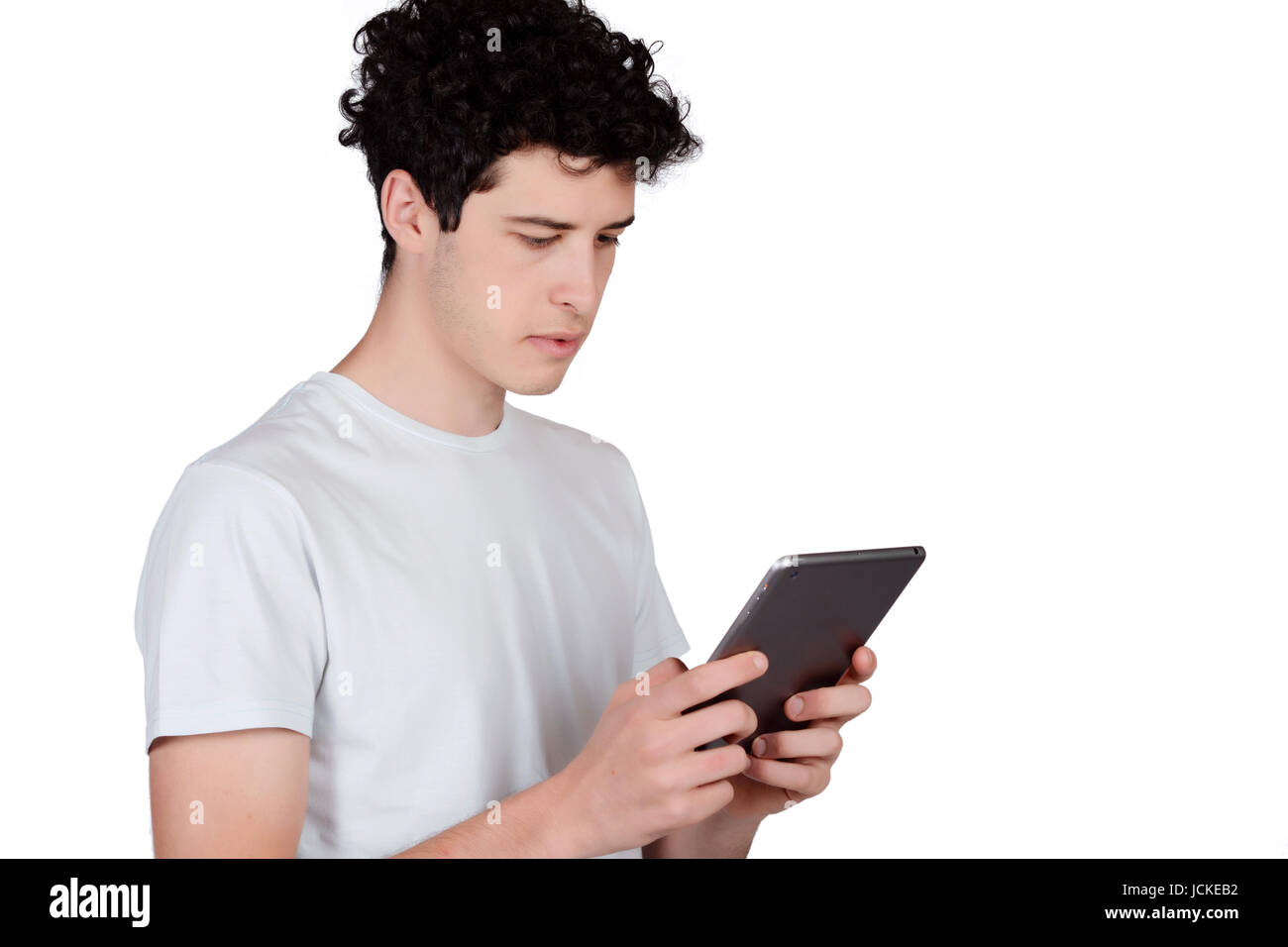 Portrait of young handsome man using tablet. Isolated white background ...