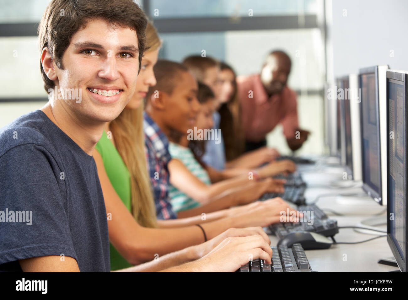 Group Of Students Working At Computers In Classroom Stock Photo - Alamy