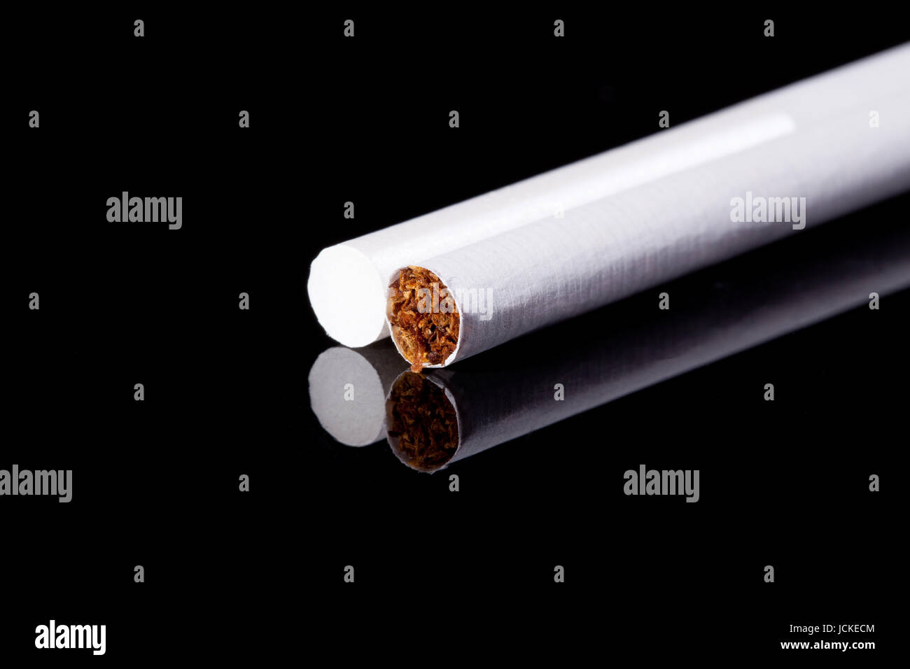 two thin cigarettes isolated on black background macro Stock Photo - Alamy