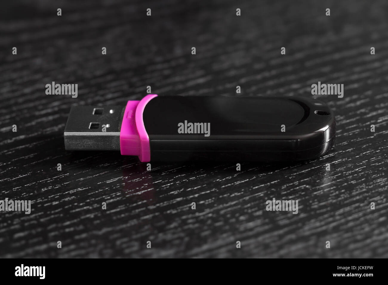 USB flash drive on a black office desk closeup Stock Photo - Alamy