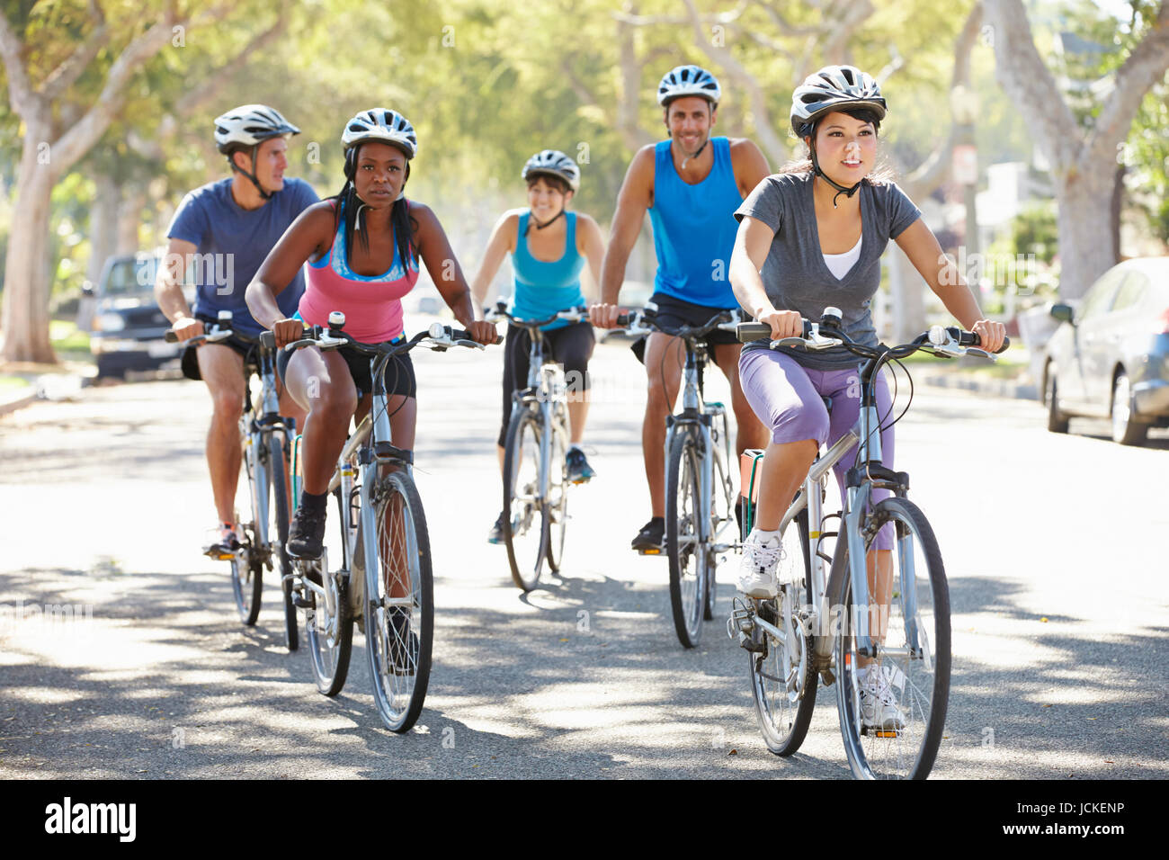 Group Of Cyclists On Suburban Street Stock Photo - Alamy