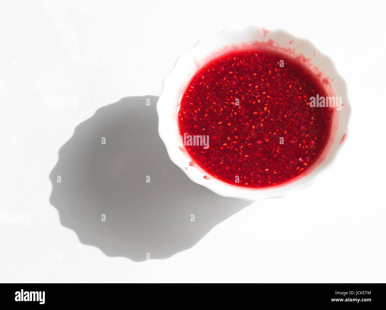 Raspberry jam in a cup closeup Stock Photo - Alamy