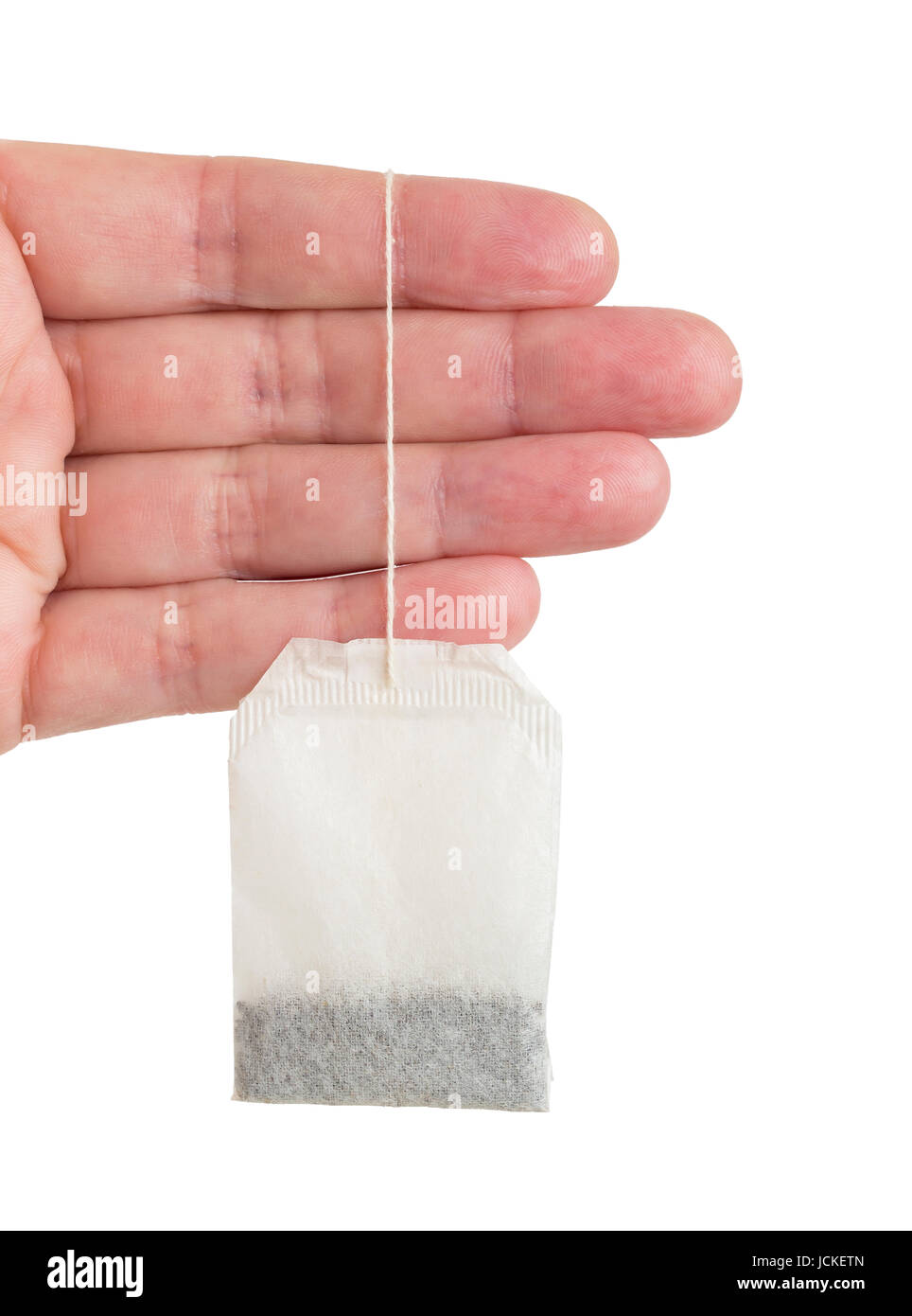 Tea bag in hand on a white background Stock Photo - Alamy