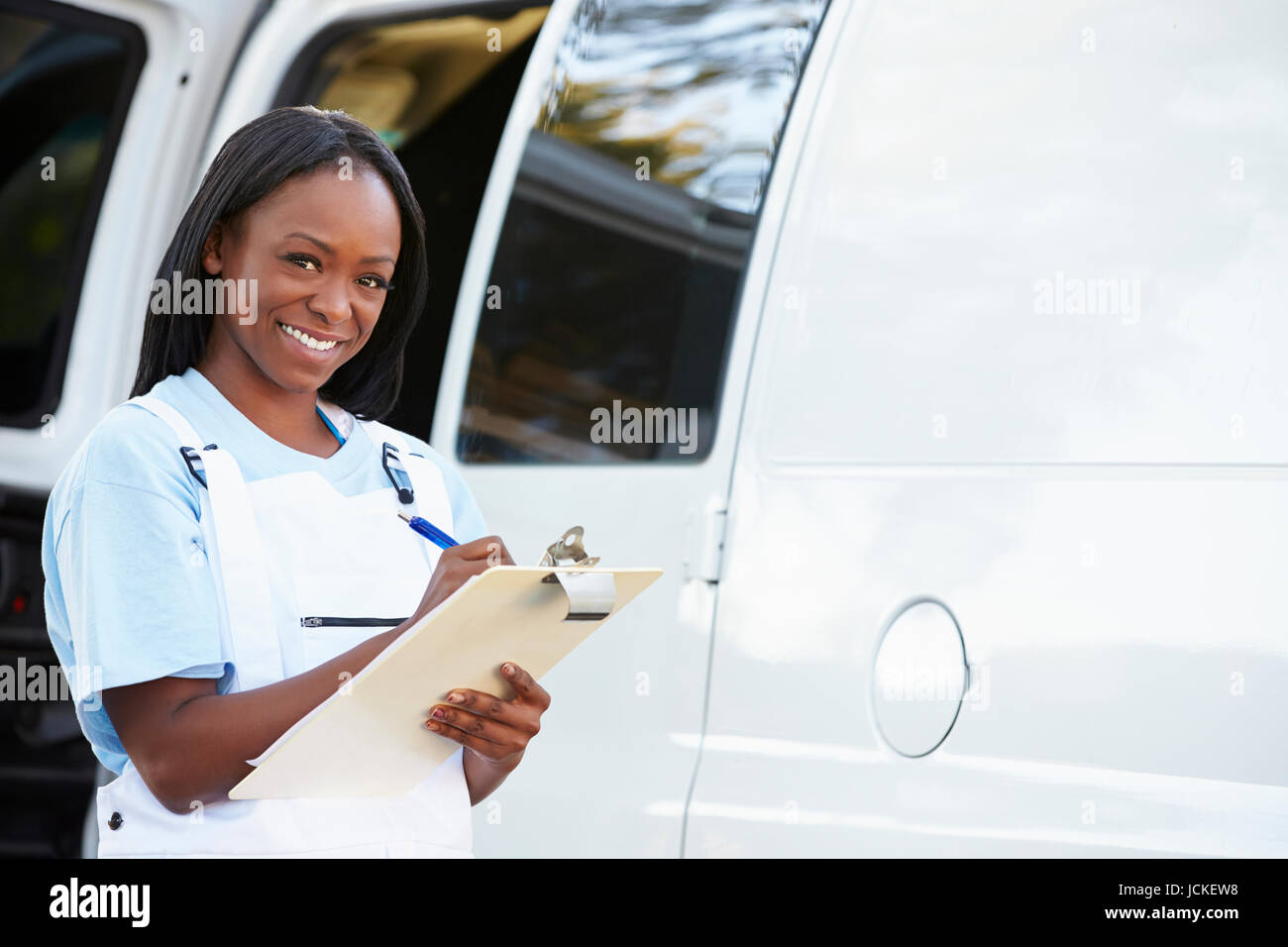 Portrait Of Female Repair Person With Van Stock Photo - Alamy