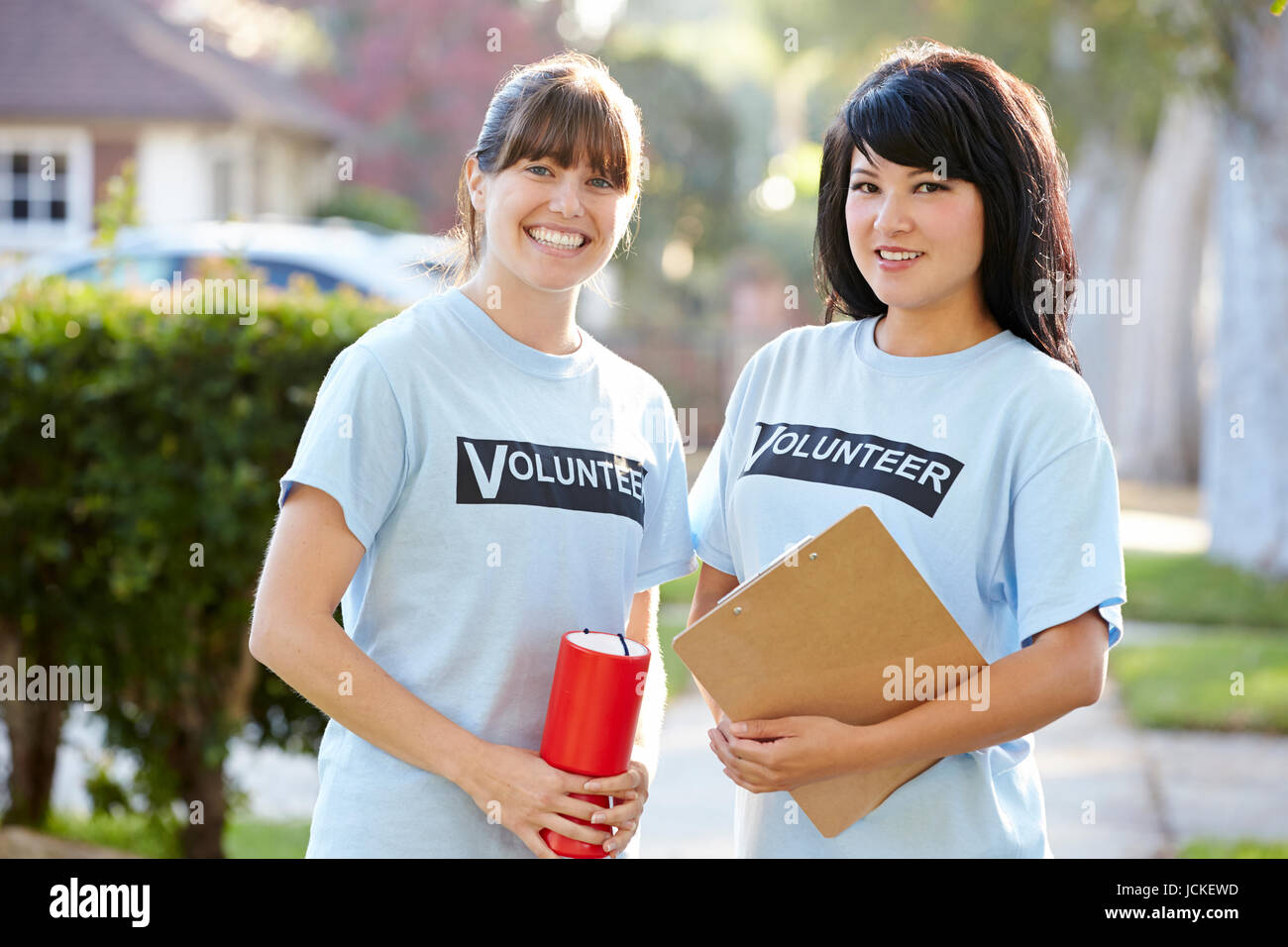 Portrait Of Two Female Charity Volunteers On Street Stock Photo - Alamy