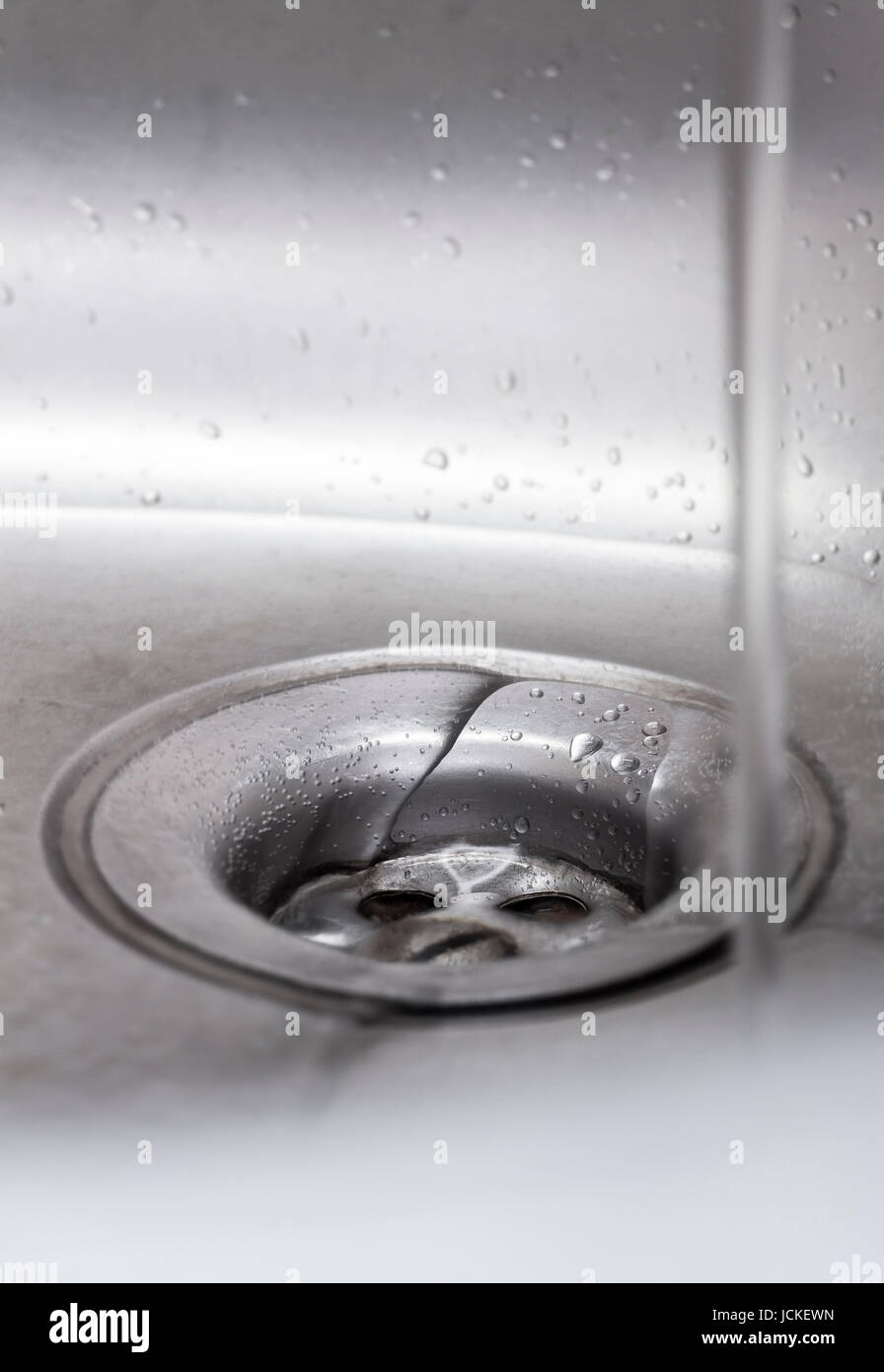 Drain hole in the kitchen sink closeup Stock Photo - Alamy