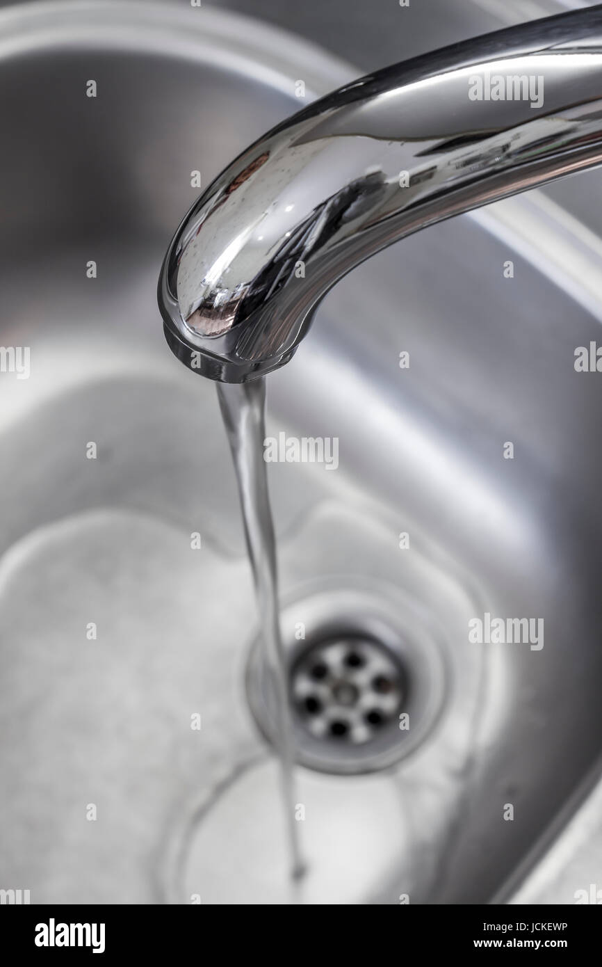 Drain hole in the kitchen sink closeup Stock Photo - Alamy