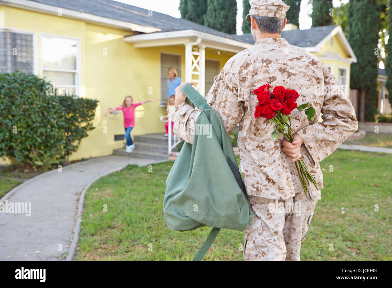 Family Welcoming Husband Home On Army Leave Stock Photo - Alamy