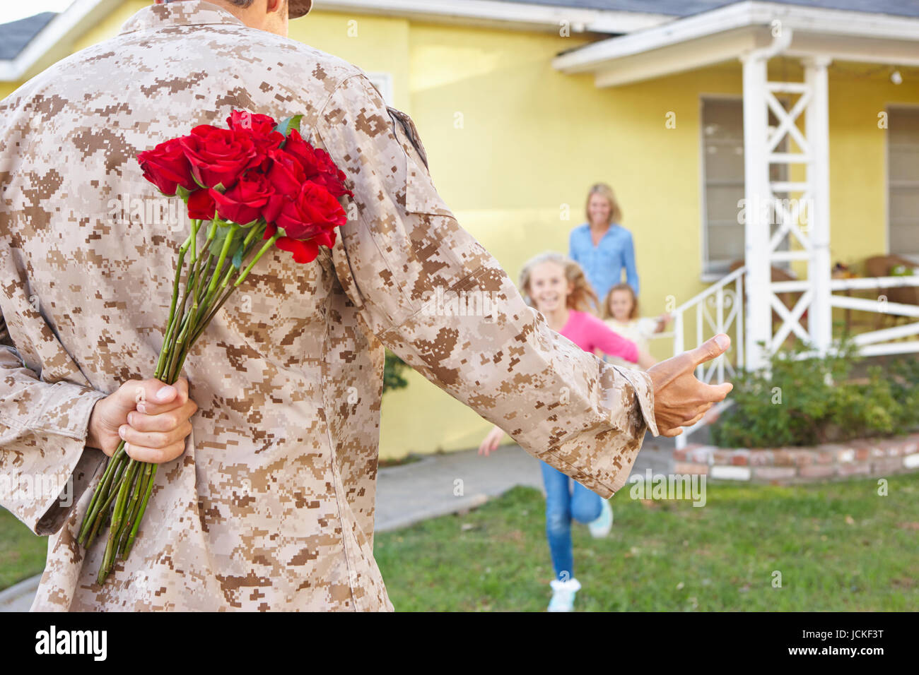 Family Welcoming Husband Home On Army Leave Stock Photo - Alamy
