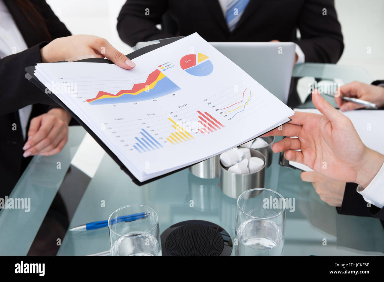 Cropped image of businesswoman giving progress chart to colleague at ...