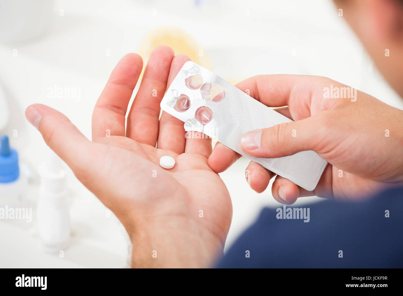 Cropped image of man taking pill out from blister pack at home Stock ...