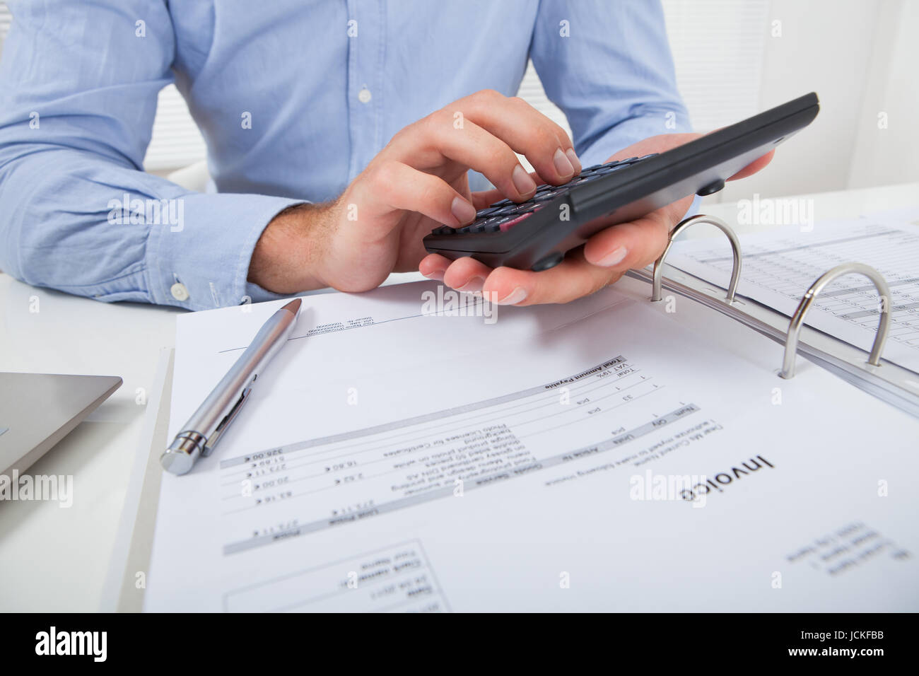Cropped image of businessman calculating tax at desk in office Stock ...