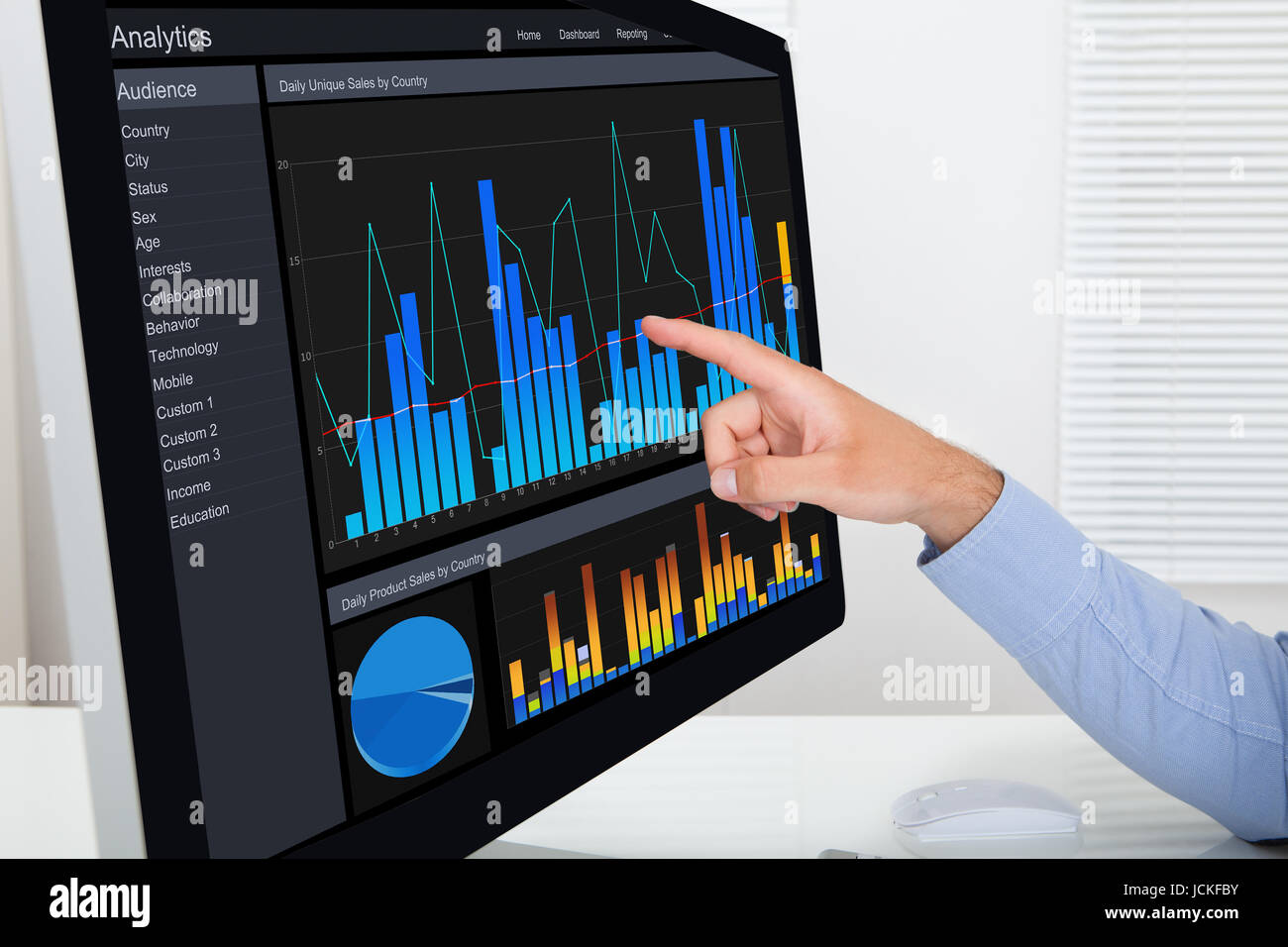 Cropped image of businessman analyzing graphs on computer in office ...