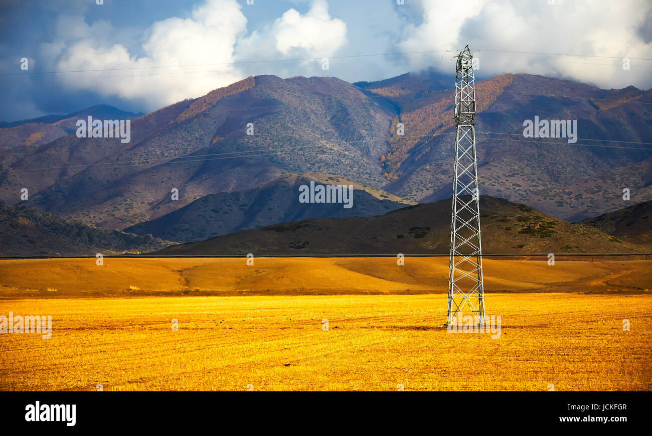 Electric Tower with yellow fields scenery in Xinjiang , China Stock ...